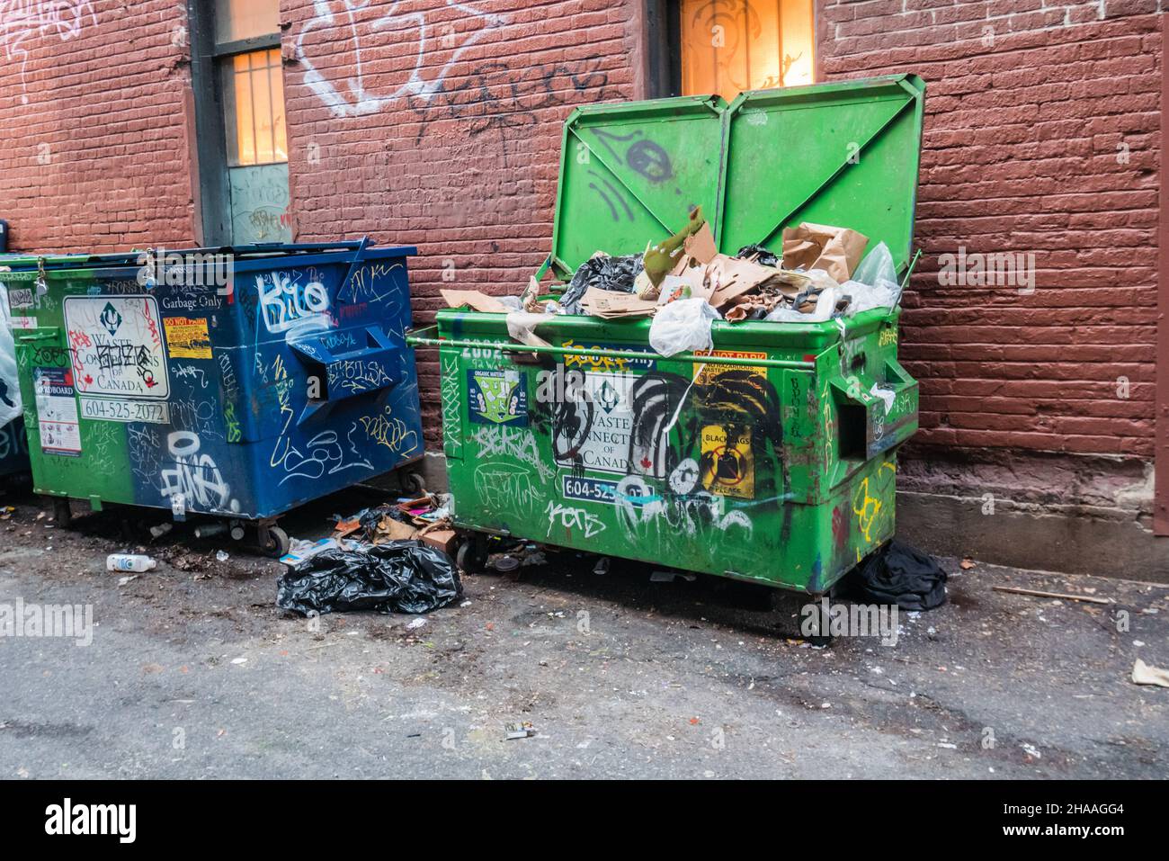 garbage in a dumpster back alley vancouver canada Stock Photo - Alamy