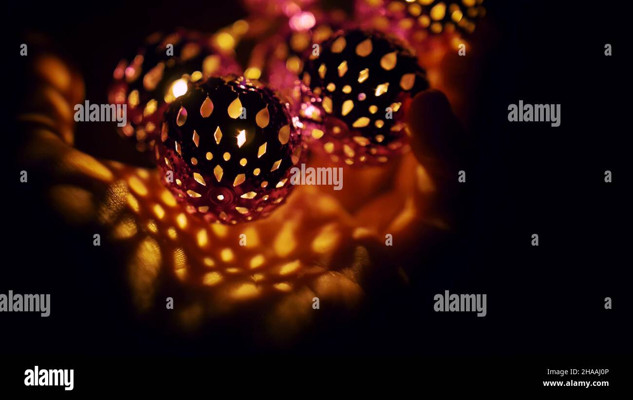 Magic lanterns spin and give beautiful glare to the walls. New Year ...