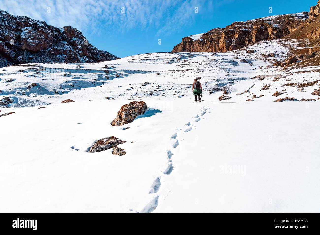 Person climbs snowy mountain trail hi-res stock photography and images ...