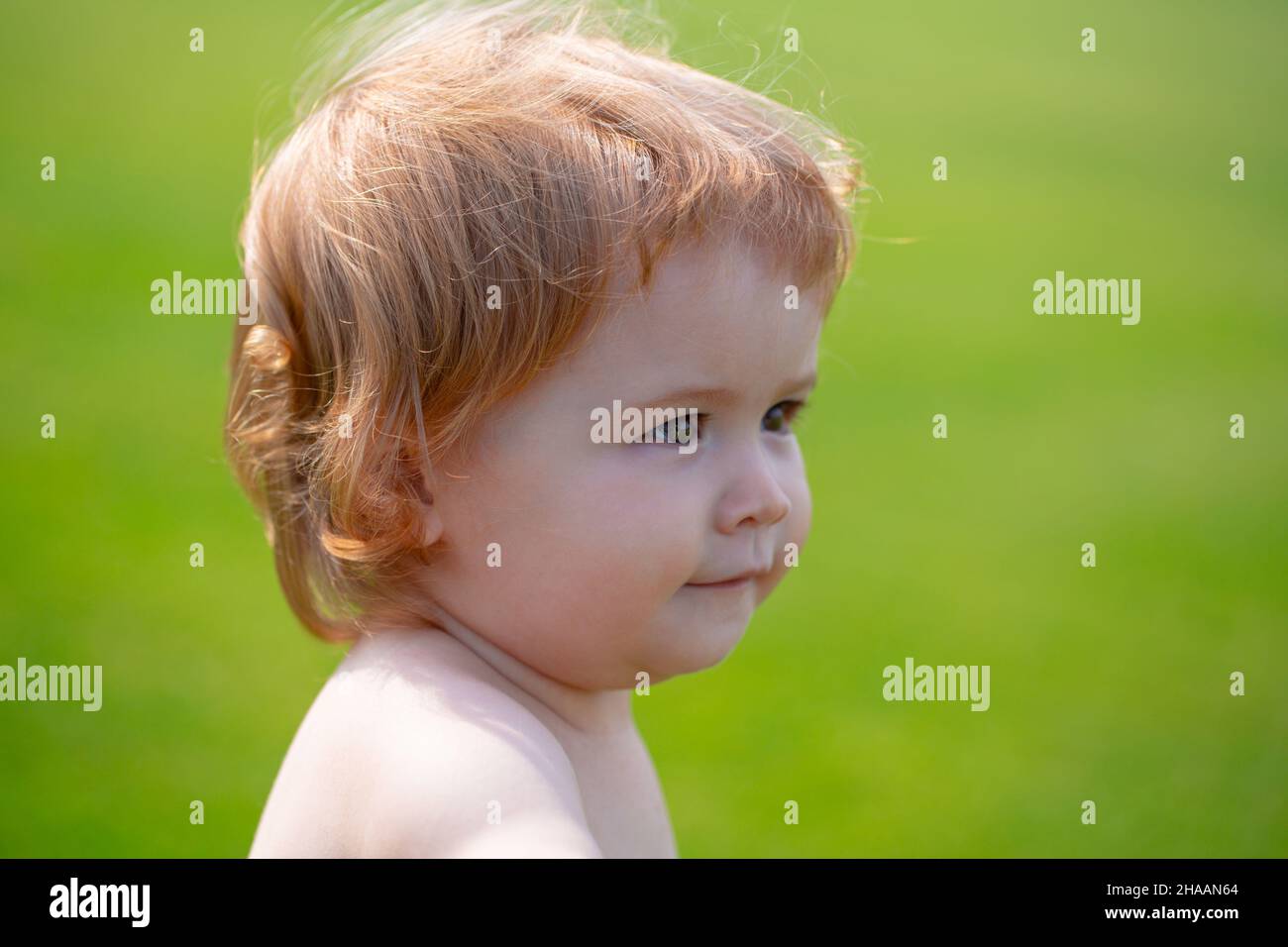 Portrait of a little baby boy playing outdoor in the grass. Baby face ... Portrait of a little baby boy playing outdoor in the grass. Baby face ...