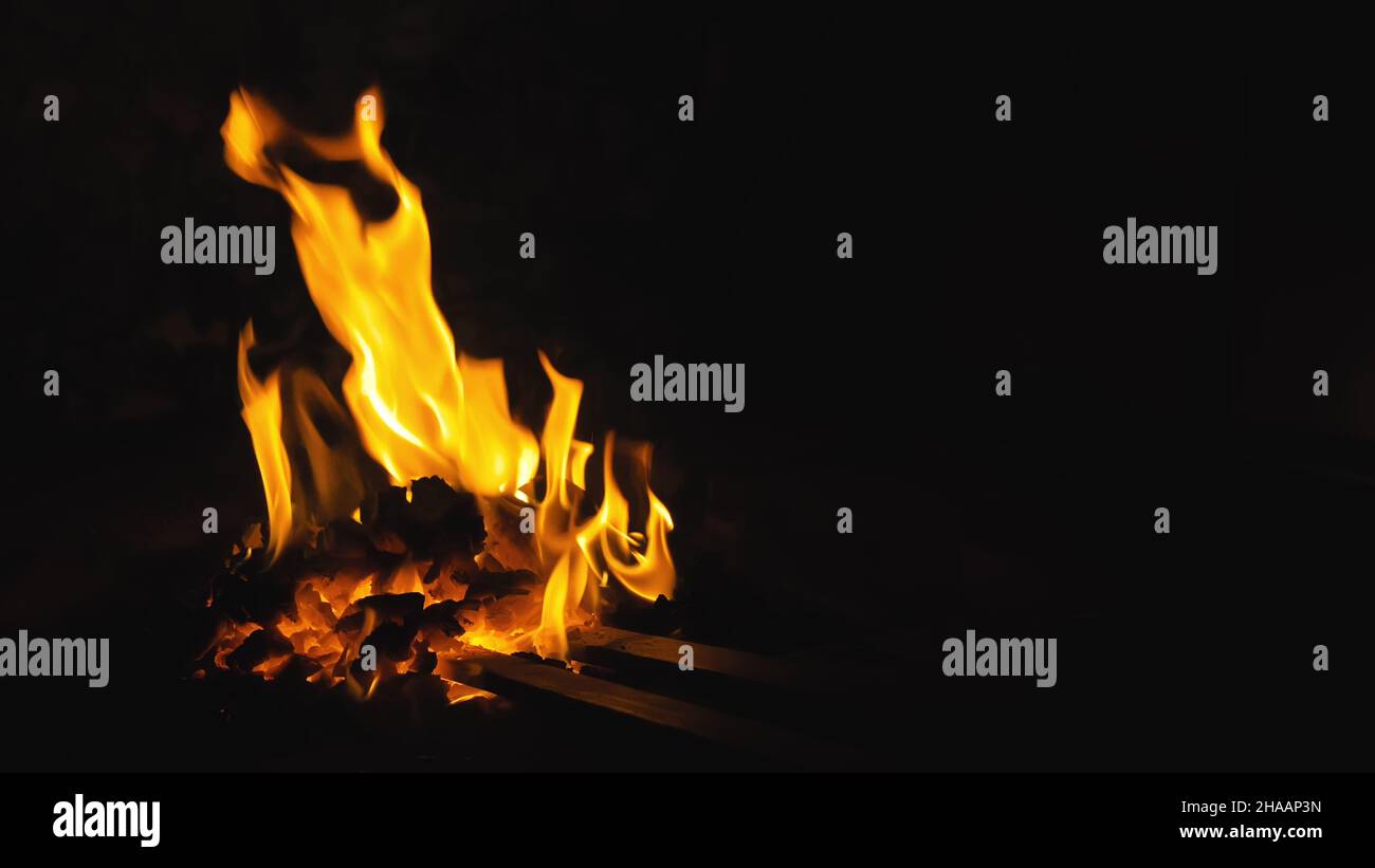 Forge fire in furnace. Blacksmith tempers a steel product in a stove ...