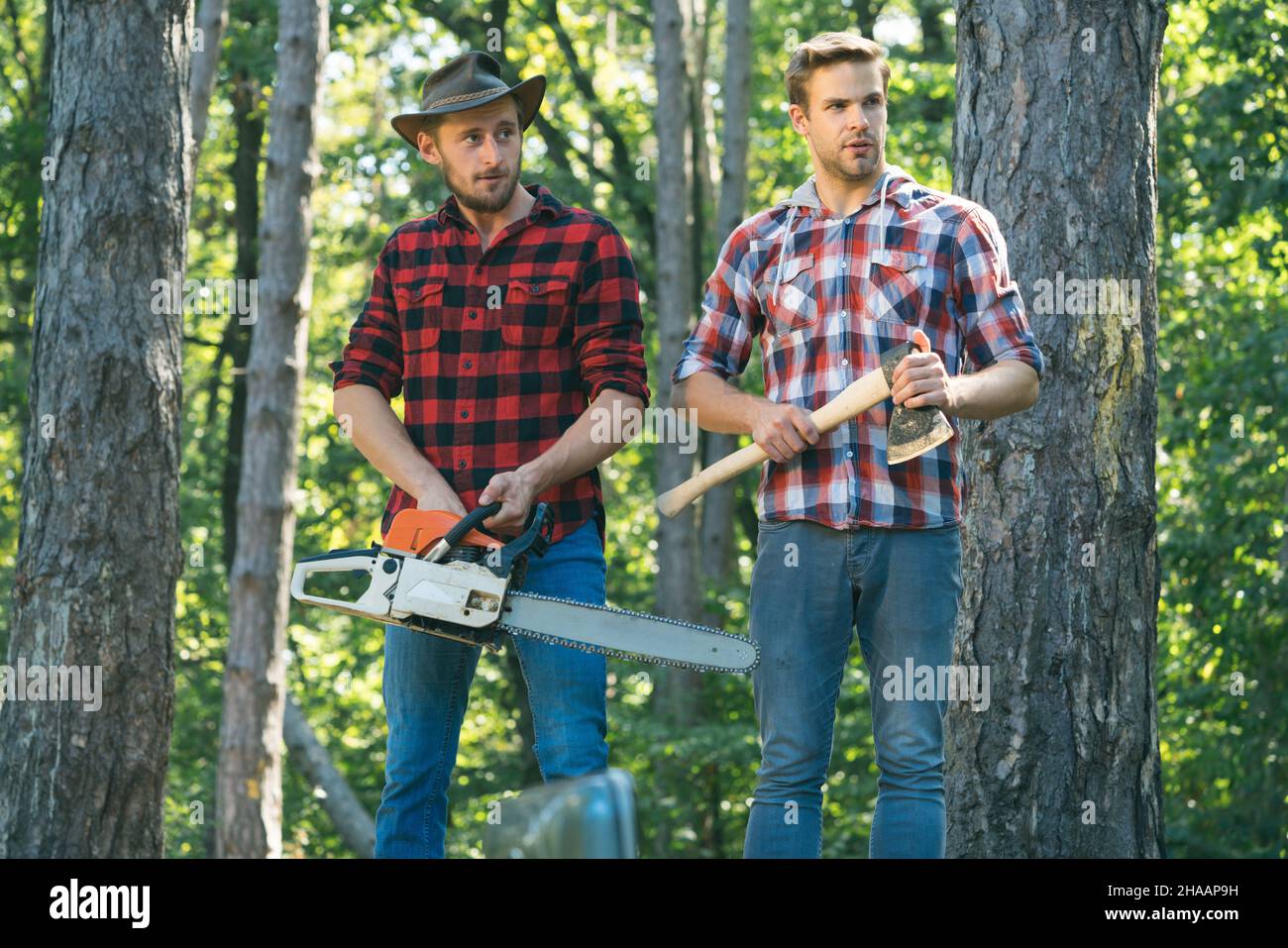 Man woodcutter holding ax. Axe in lumberjack hands cutting wood ...