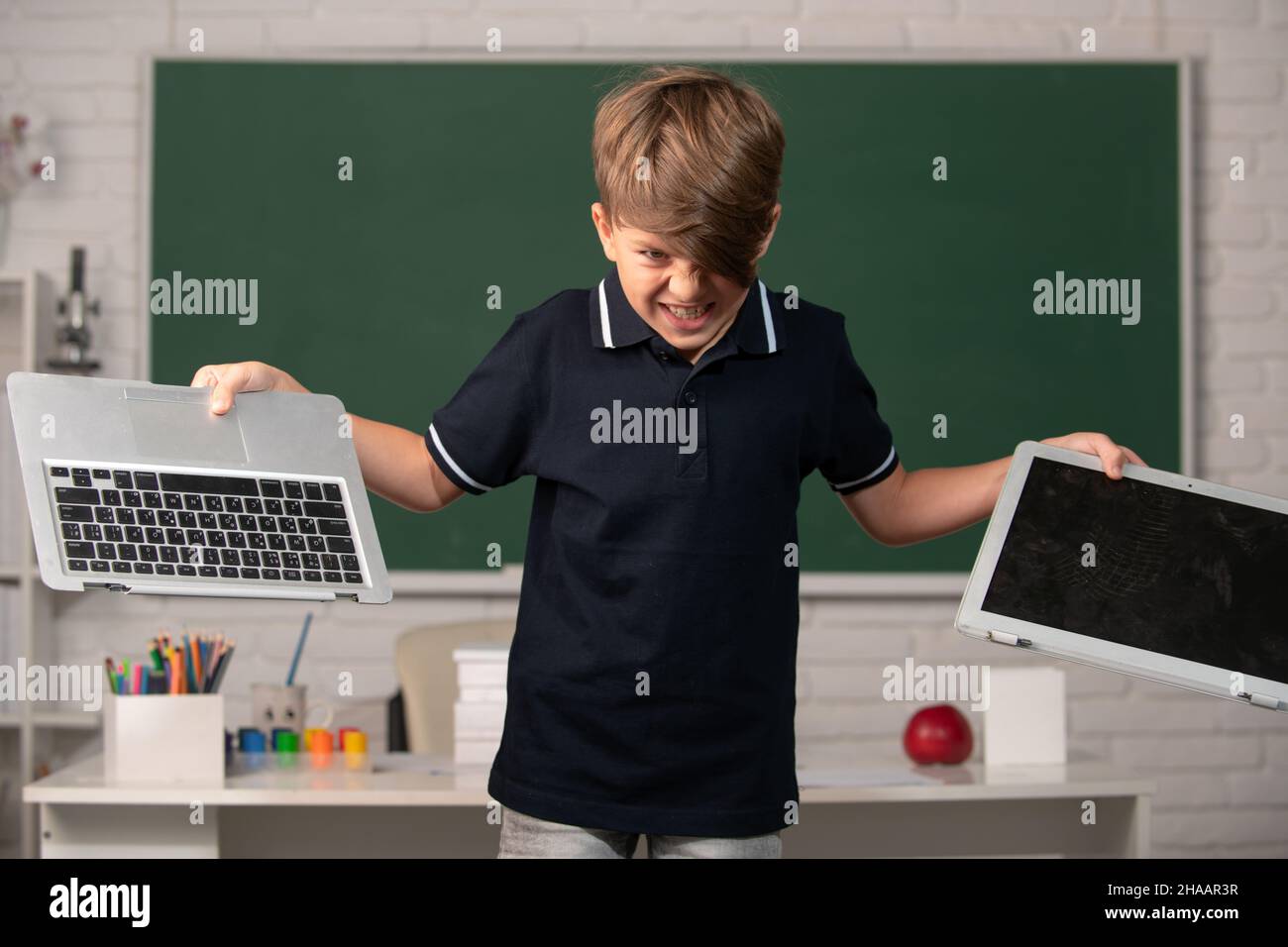 Bad boy student vs distance education. Angry kid broken online laptop ...