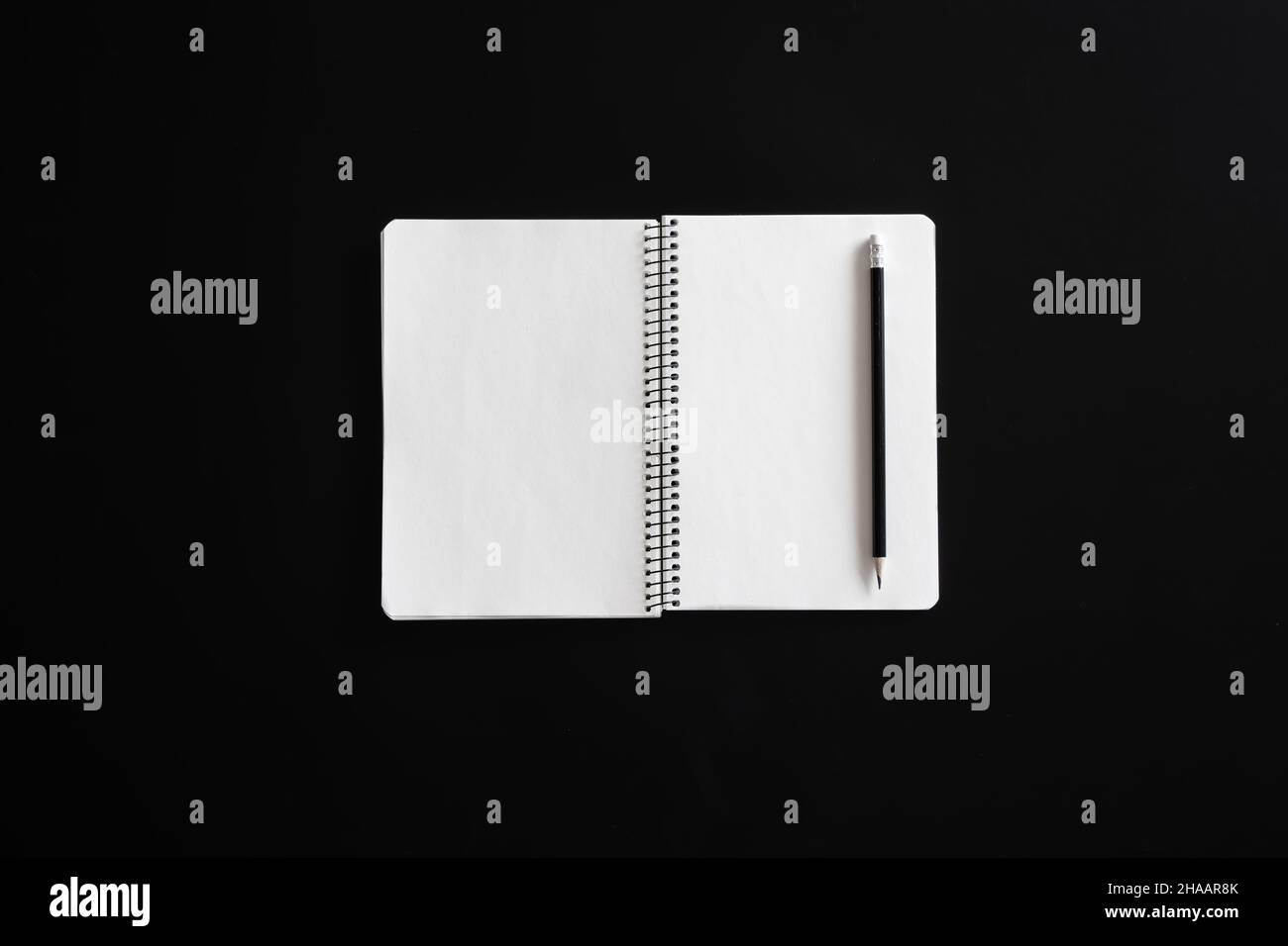 Open blank notebook on springs on black background, flat lay Stock ...
