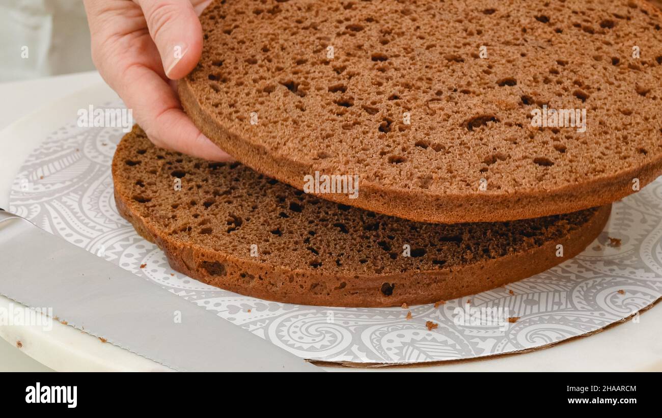 Assembling chocolate cake. Step by step baking process, close up view ...