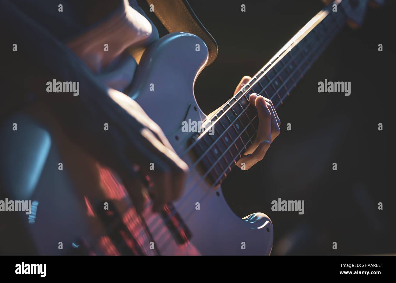 Close-up of a man playing the bass guitar Stock Photo - Alamy