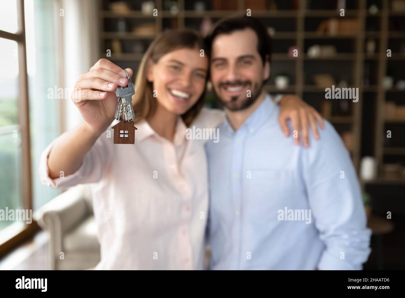 Happy young family couple of tenants receiving, holding keys Stock ...