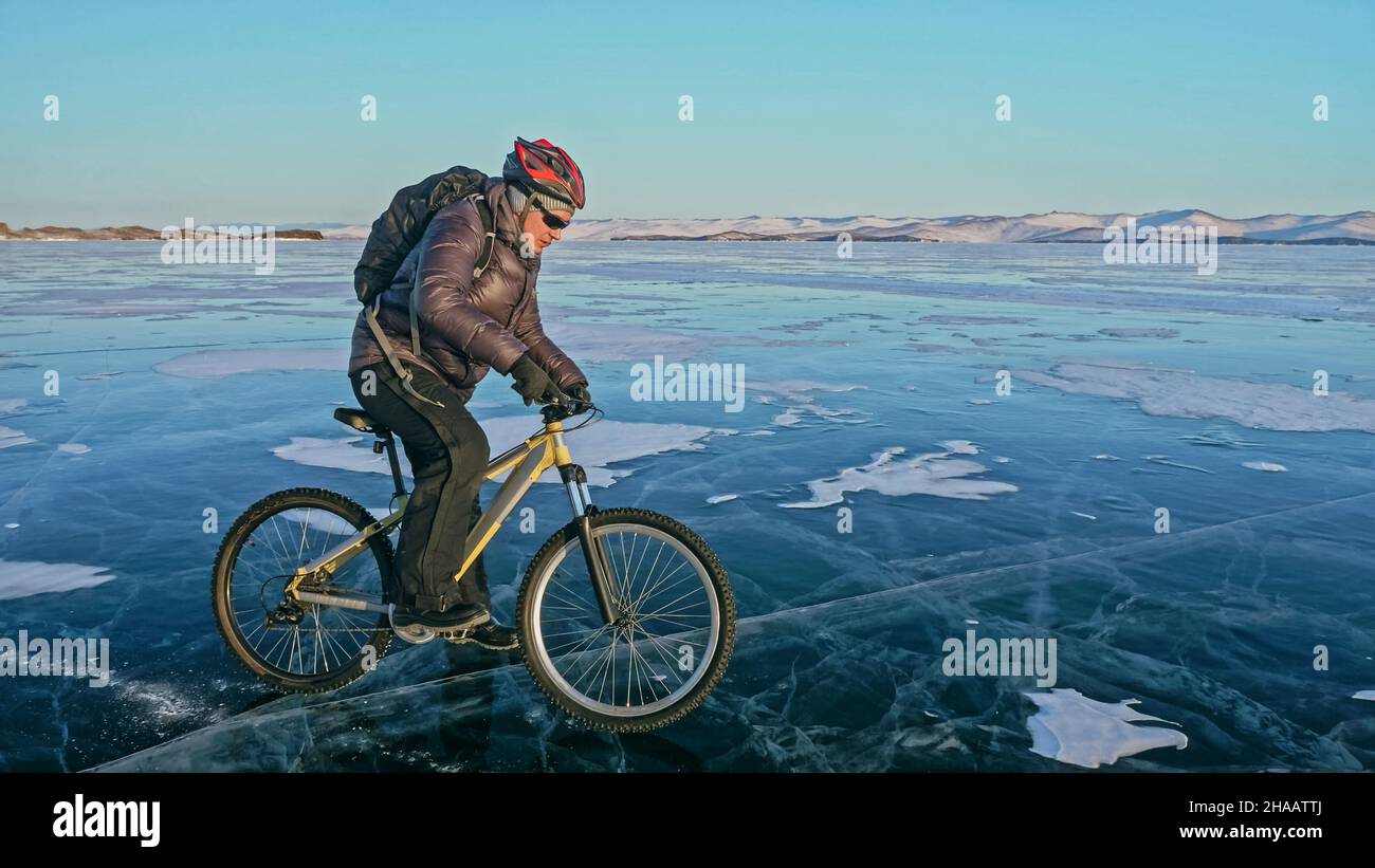 Man is riding bicycle on the ice. Ice of frozen Lake Baikal. Rid Stock ...