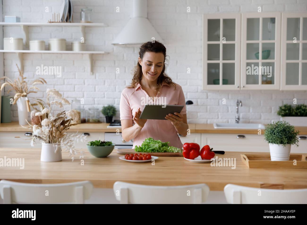 Young female home using tablet hi-res stock photography and images - Alamy
