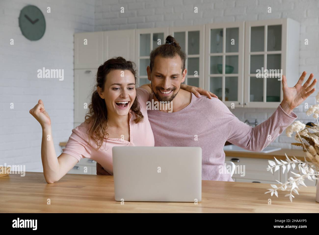 Cheerful excited couple celebrating achieve at computer Stock Photo - Alamy