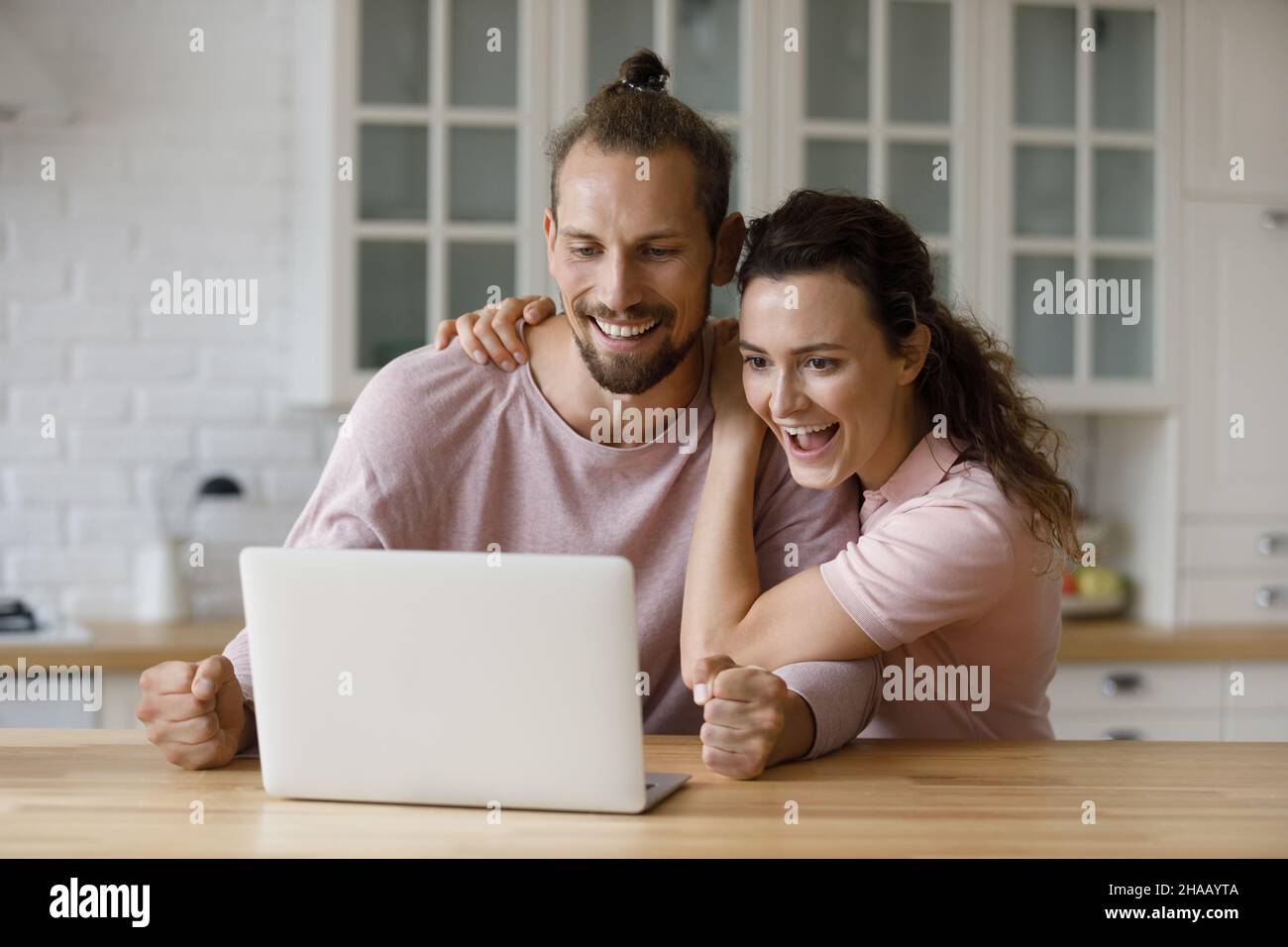Happy excited young married couple receiving amazing good news Stock ...