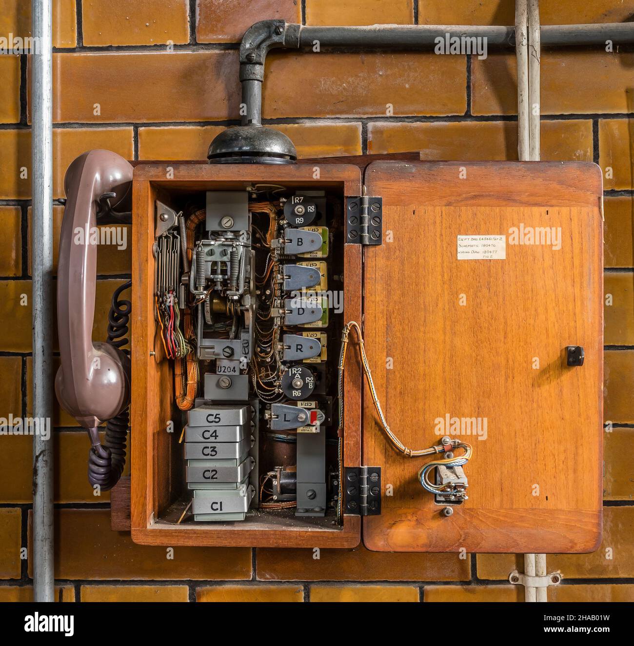 Old wooden railway substation telephone mounted on a wall showing ...