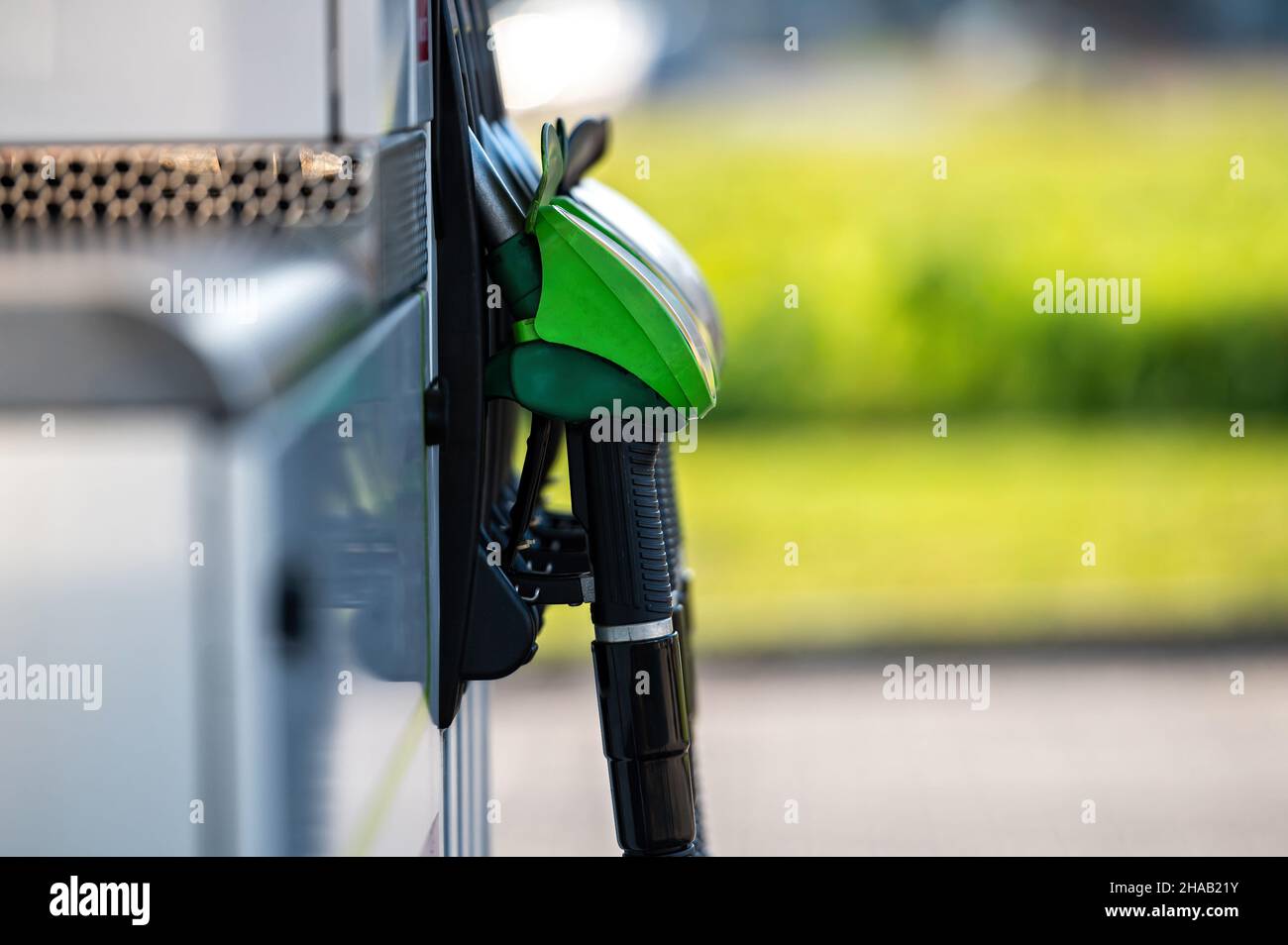 row with green and black refueling guns at the gas station, closeup ...