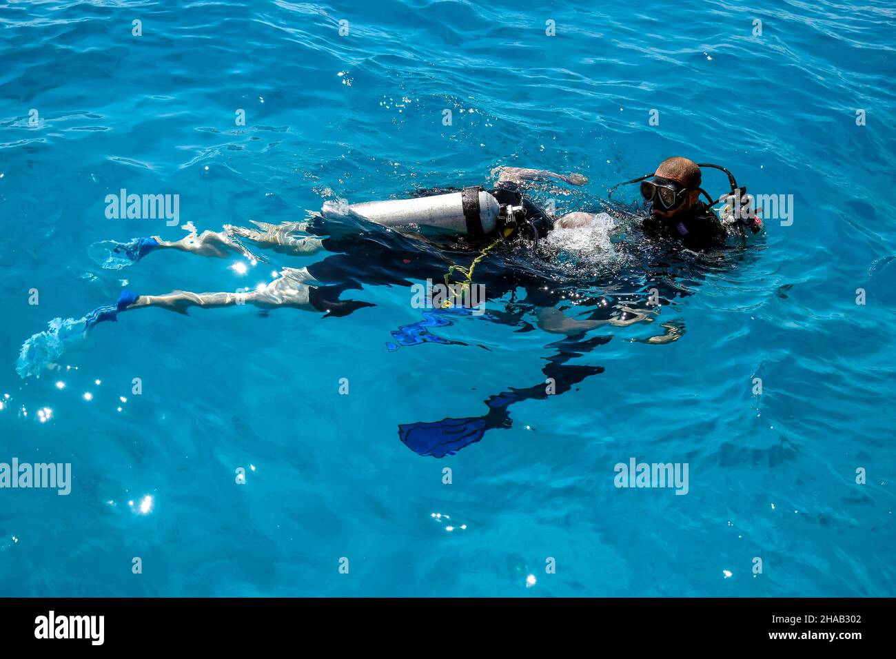 Learning process of scuba diving. Experienced instructor teaches ...