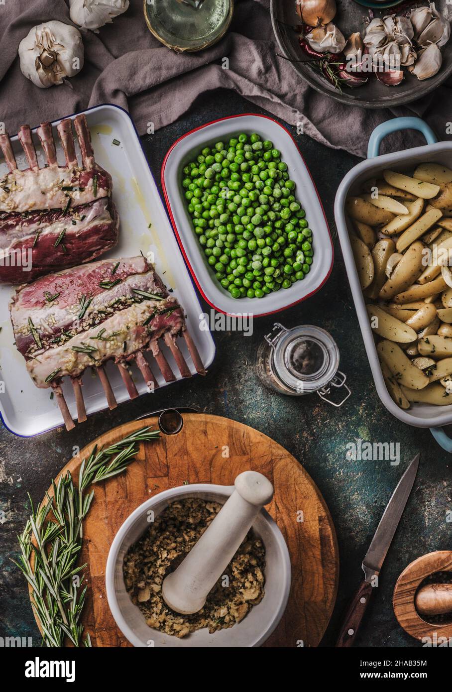 Food background with raw lamb ribs, green peas, potatoes, kitchen ...