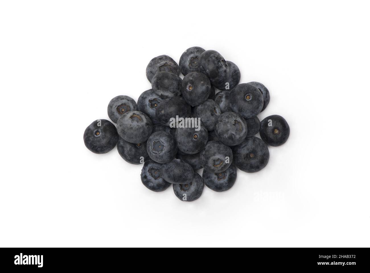 a heap of dark blue blueberries seen from above isolated on white ...