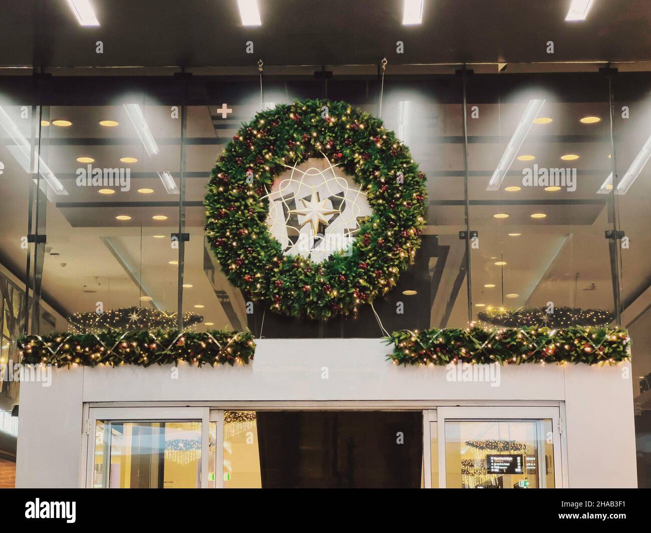 Shopping mall exterior decorated with christmas trees Stock Photo - Alamy