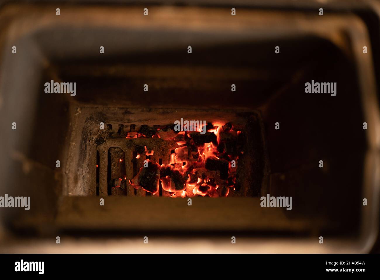 A closeup of burning coals in a stone hole Stock Photo - Alamy