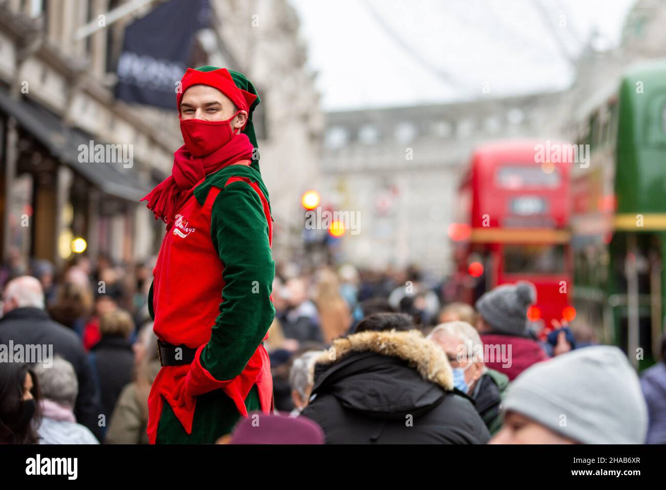 London, UK. 11th Dec, 2021. Hamleys staff dressed as Elf entertains ...