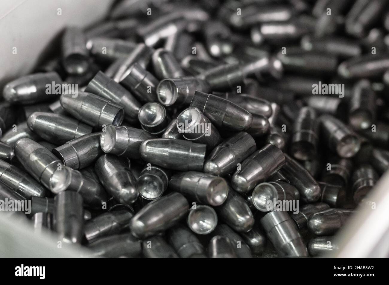 Pile of small caliber hunter bullets in plastic container Stock Photo ...