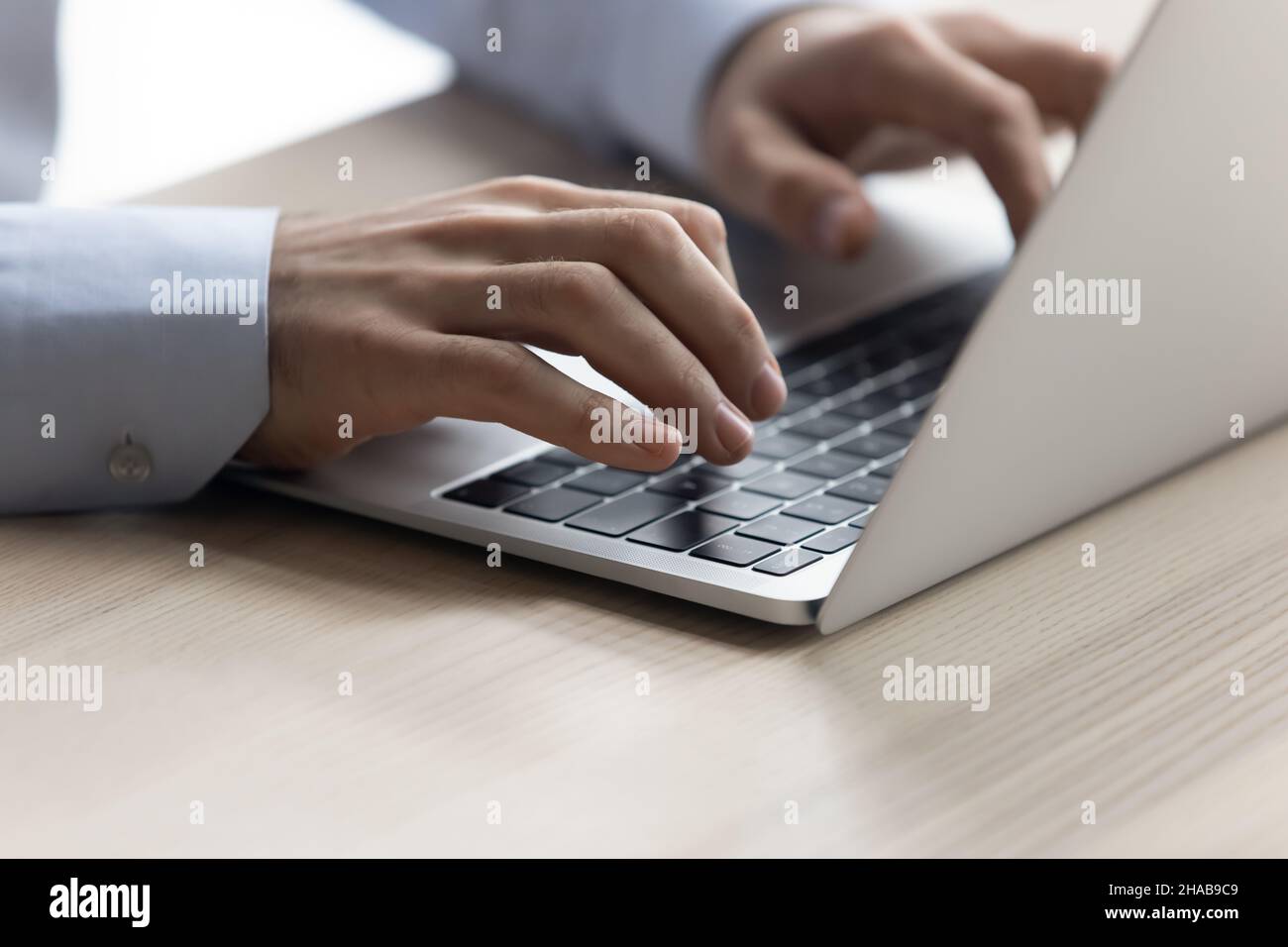 Businessman texting on laptop sit at workplace desk, close up Stock ...