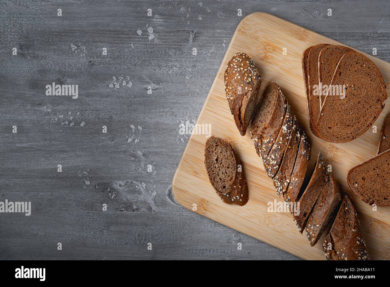 Sliced rye bread on a wood cutting board with grain Stock Photo - Alamy