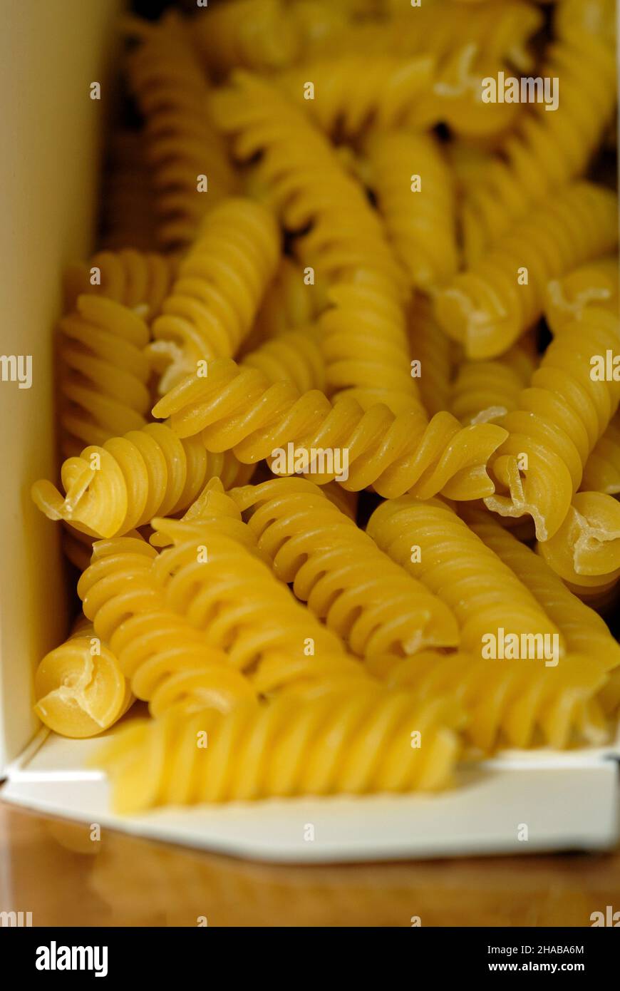 Italian pasta in an open carton before cooking closeup. Shallow depth ...