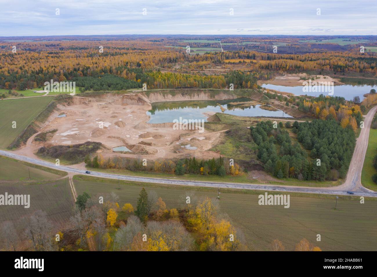Aerial view of an opencast sand, gravel mine quarry full with green ...