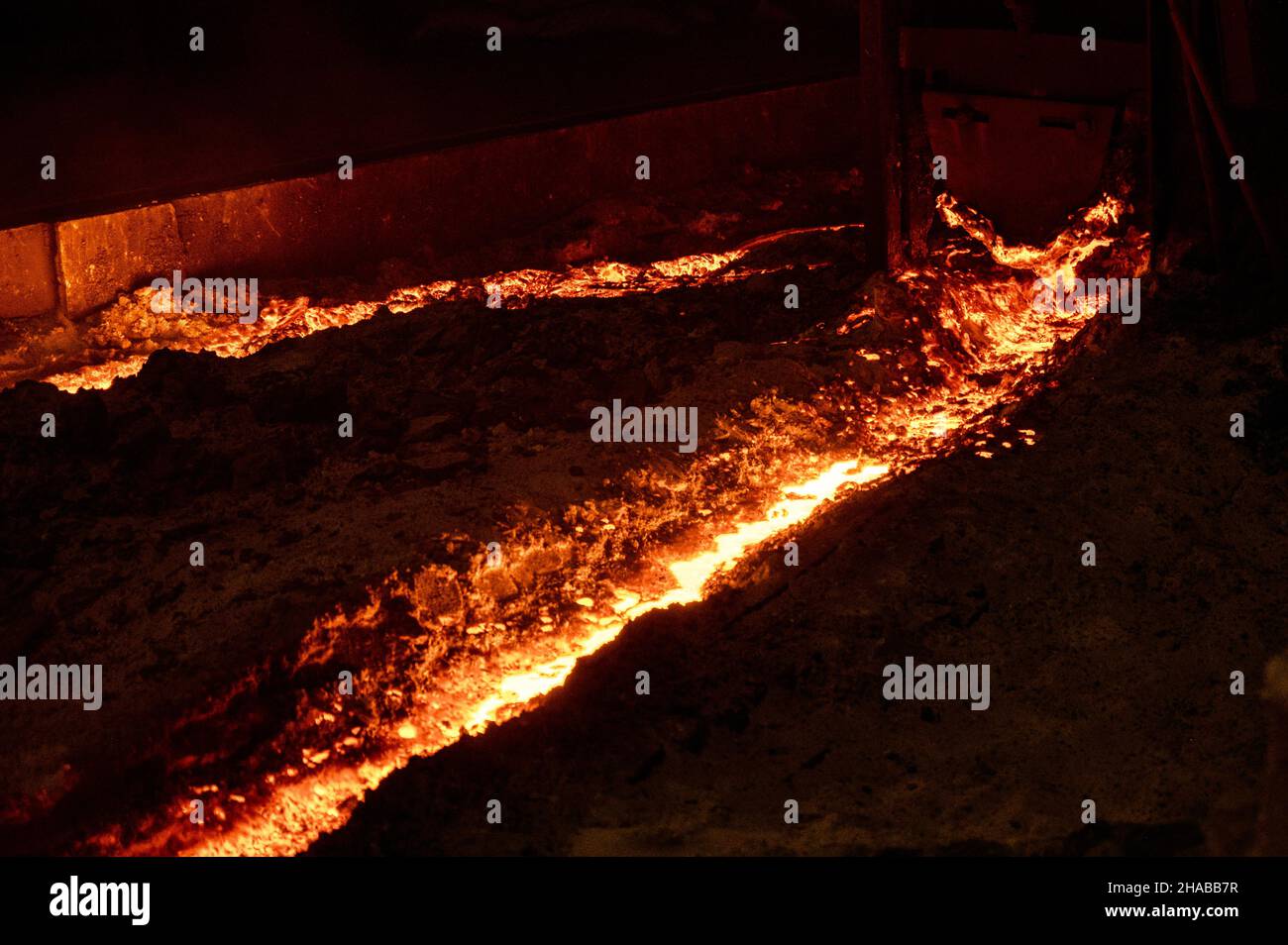 A stream of liquid metal flowing in a sandy channel Stock Photo - Alamy