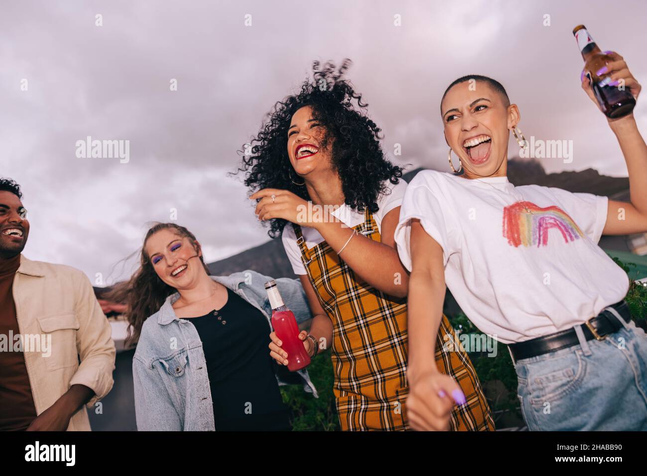 Cheerful friends partying on a rooftop. Group of happy generation z ...