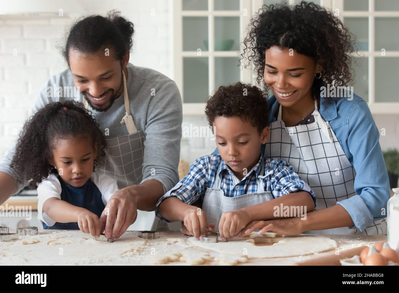 Loving African family cooking together in modern kitchen Stock Photo ...