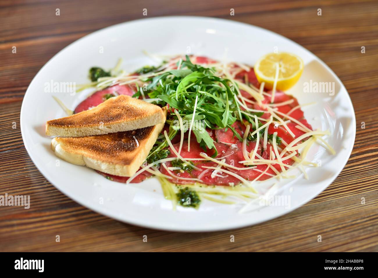Black angus beef carpaccio with parmesan cheese on a plate Stock Photo ...