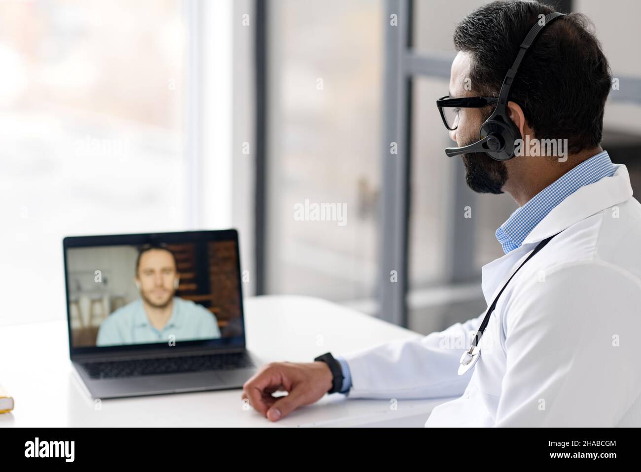 Doctor's appointment on the distance. Indian male doctor using laptop ...