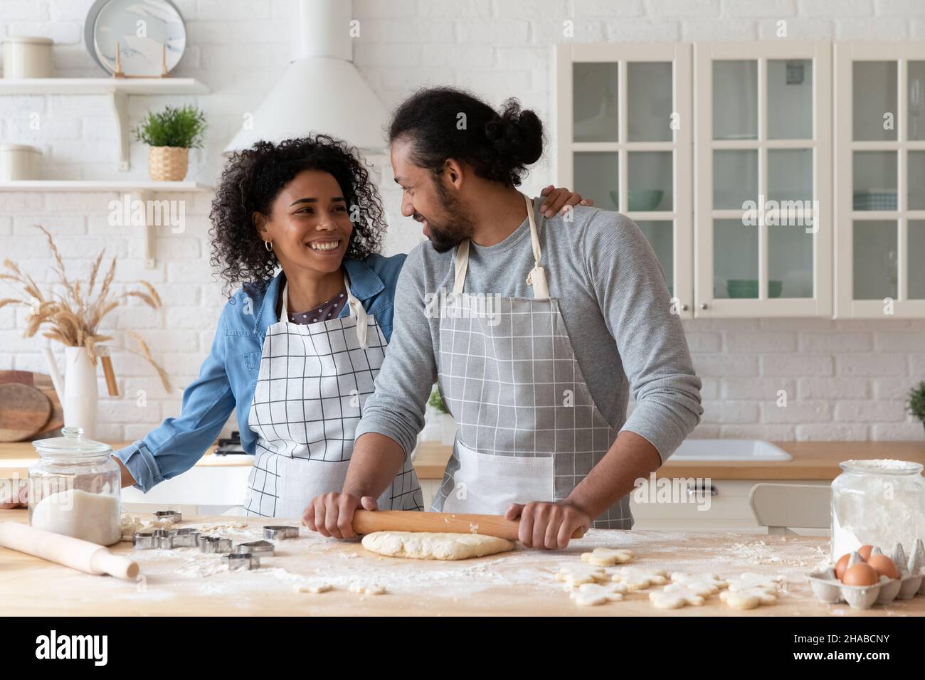 African couple in love cooking together in modern kitchen Stock Photo ...