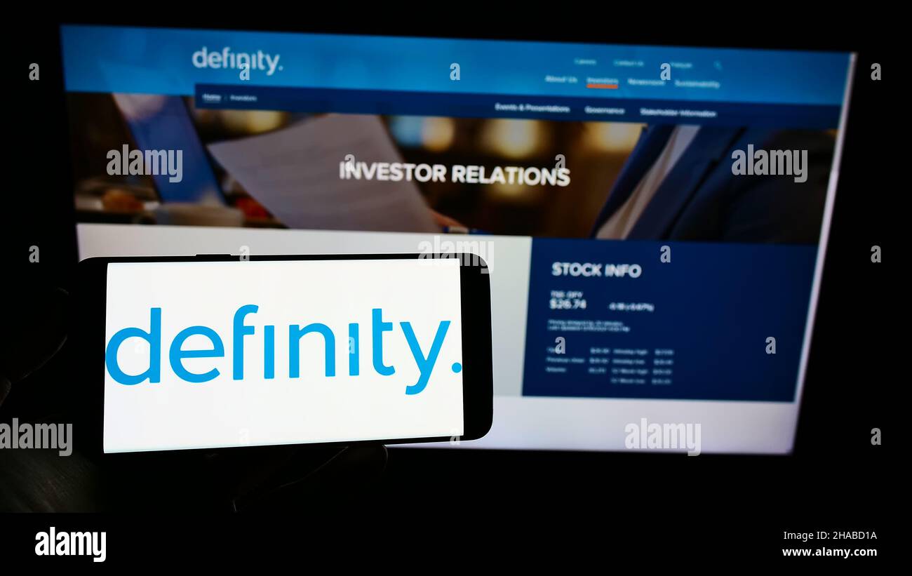 Person holding smartphone with logo of financial company Definity ...
