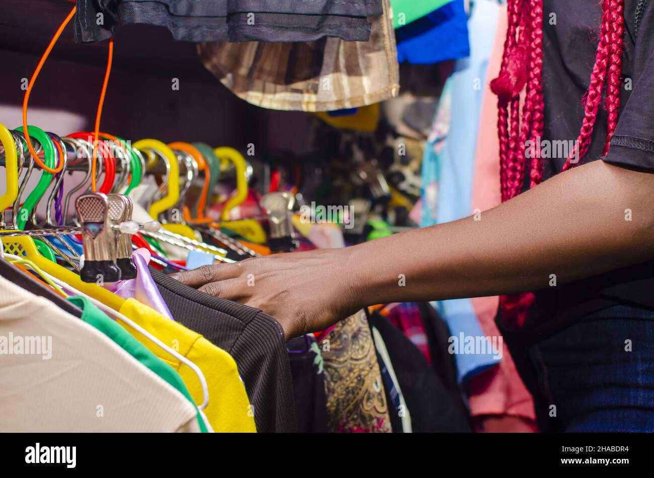 A black beautiful Nigerian girl with rasta red hair exploring jackets ...