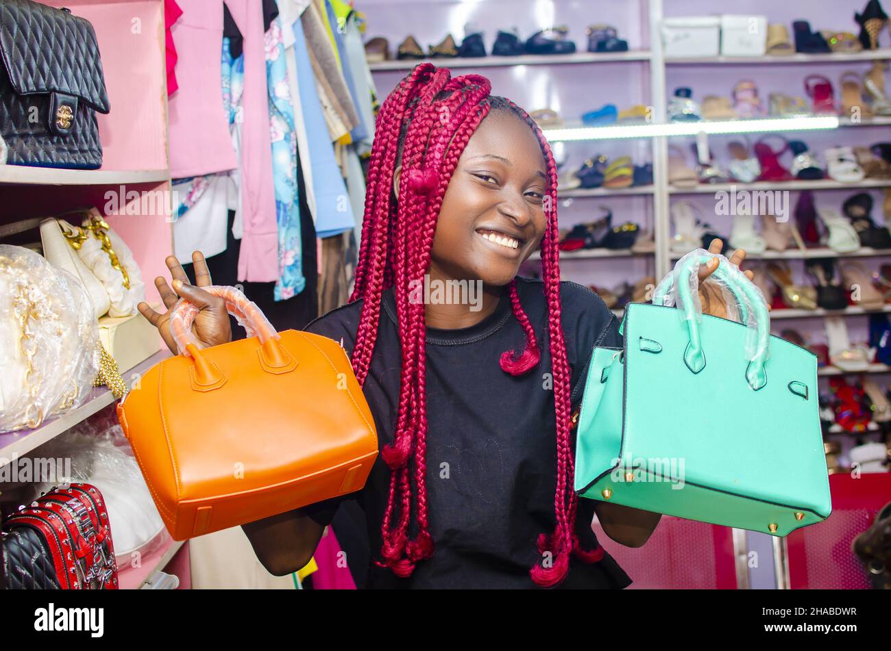 A black beautiful Nigerian girl with rasta red hair holding a green and ...