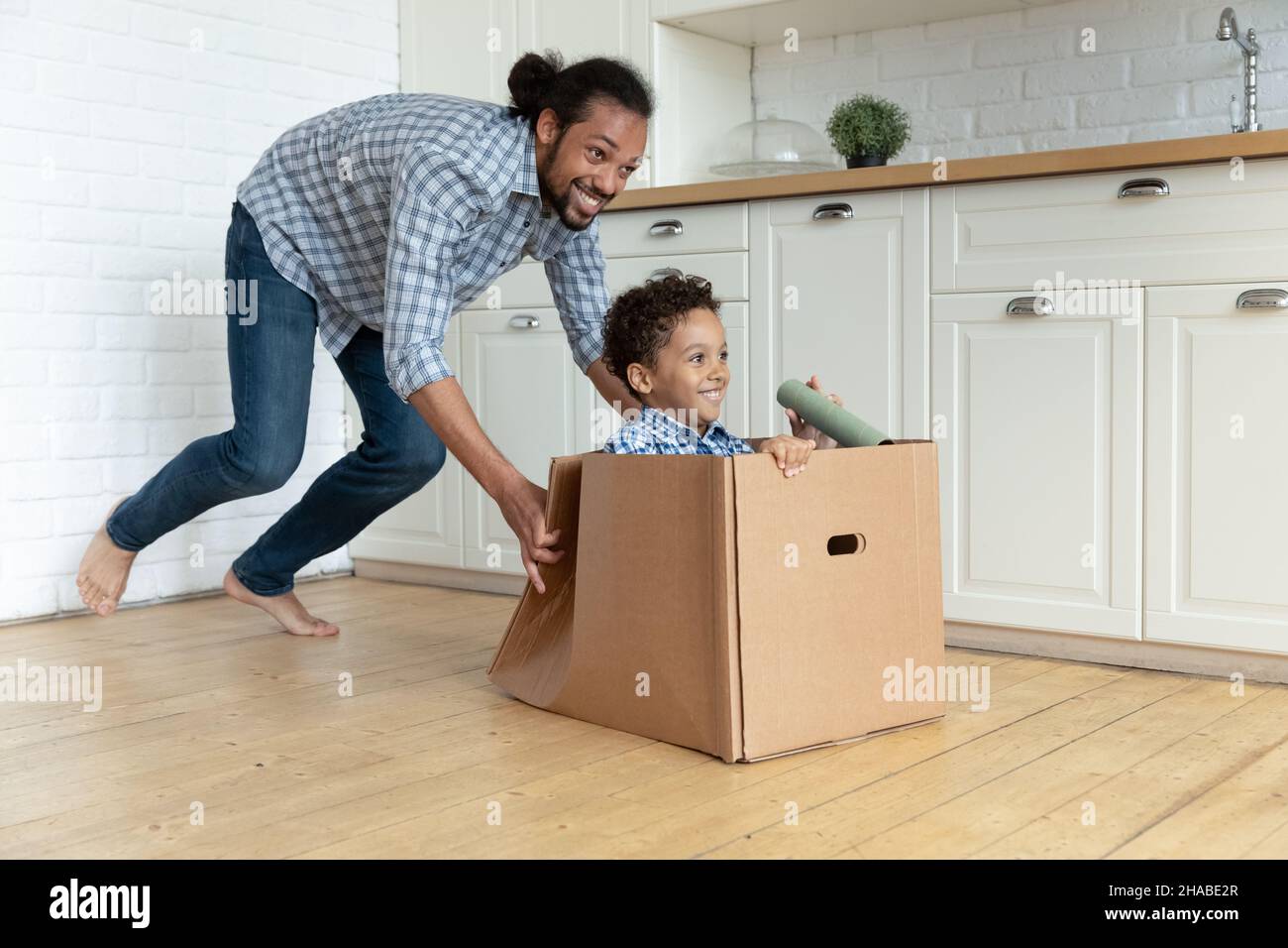 Little African boy enjoy playtime ride sit inside carton box Stock ...