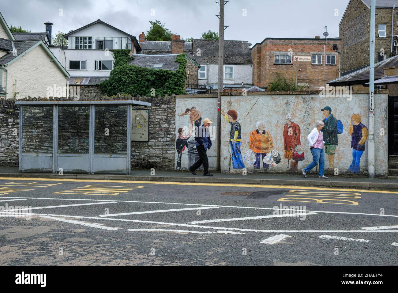 A bus stop with a mural depicting local people waiting for a bus ...
