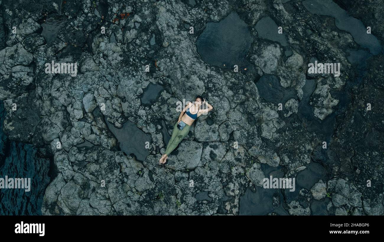 beautiful girl lies on the lava. view from above Stock Photo - Alamy