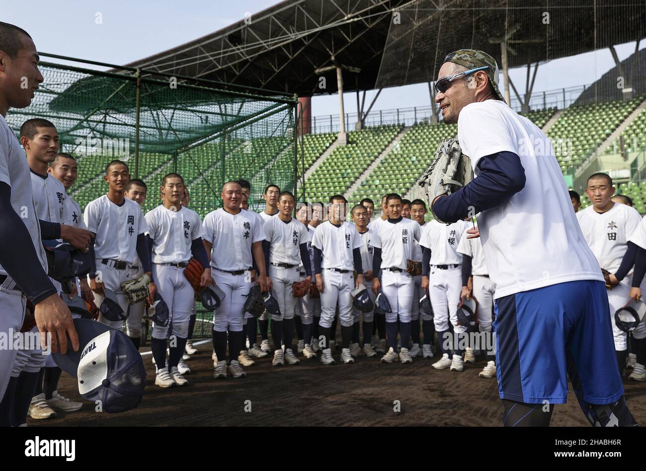 Former Seattle Mariners outfielder Ichiro Suzuki (front R) coaches Takamatsu Shogyo high school ...