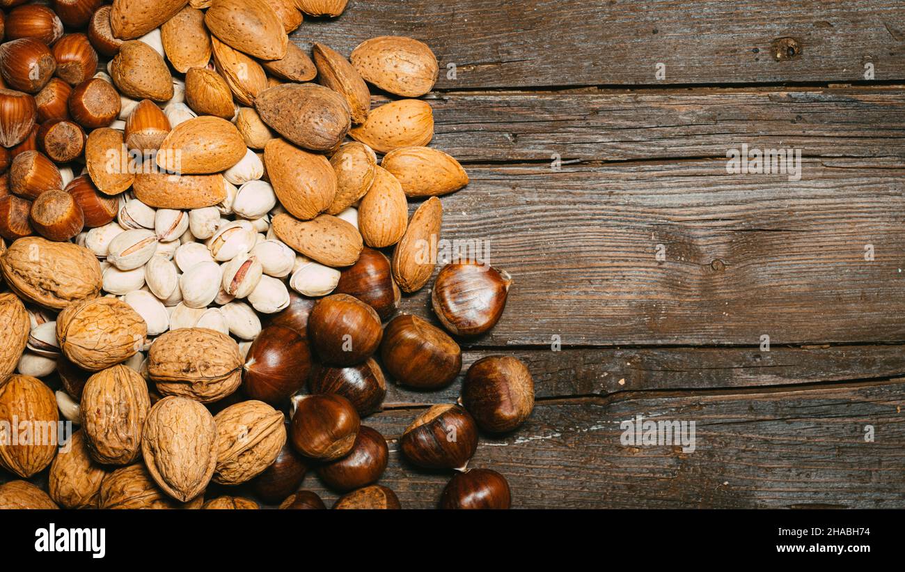 overhead shot of pistachios, almonds, walnuts, chestnuts and hazelnuts ...