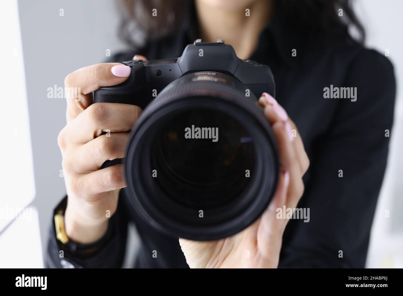 Professional woman photographer hold last model of photocamera Stock ...