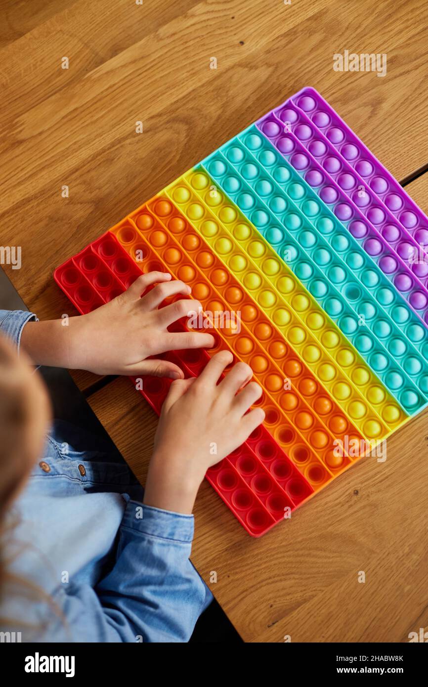 Little girl playing with big silicone popit, simple dimple, bubble ...