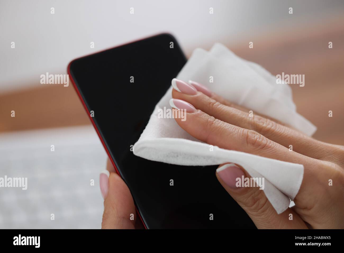 Woman clean mobile phone screen with wet wipe, antibacterial and ...