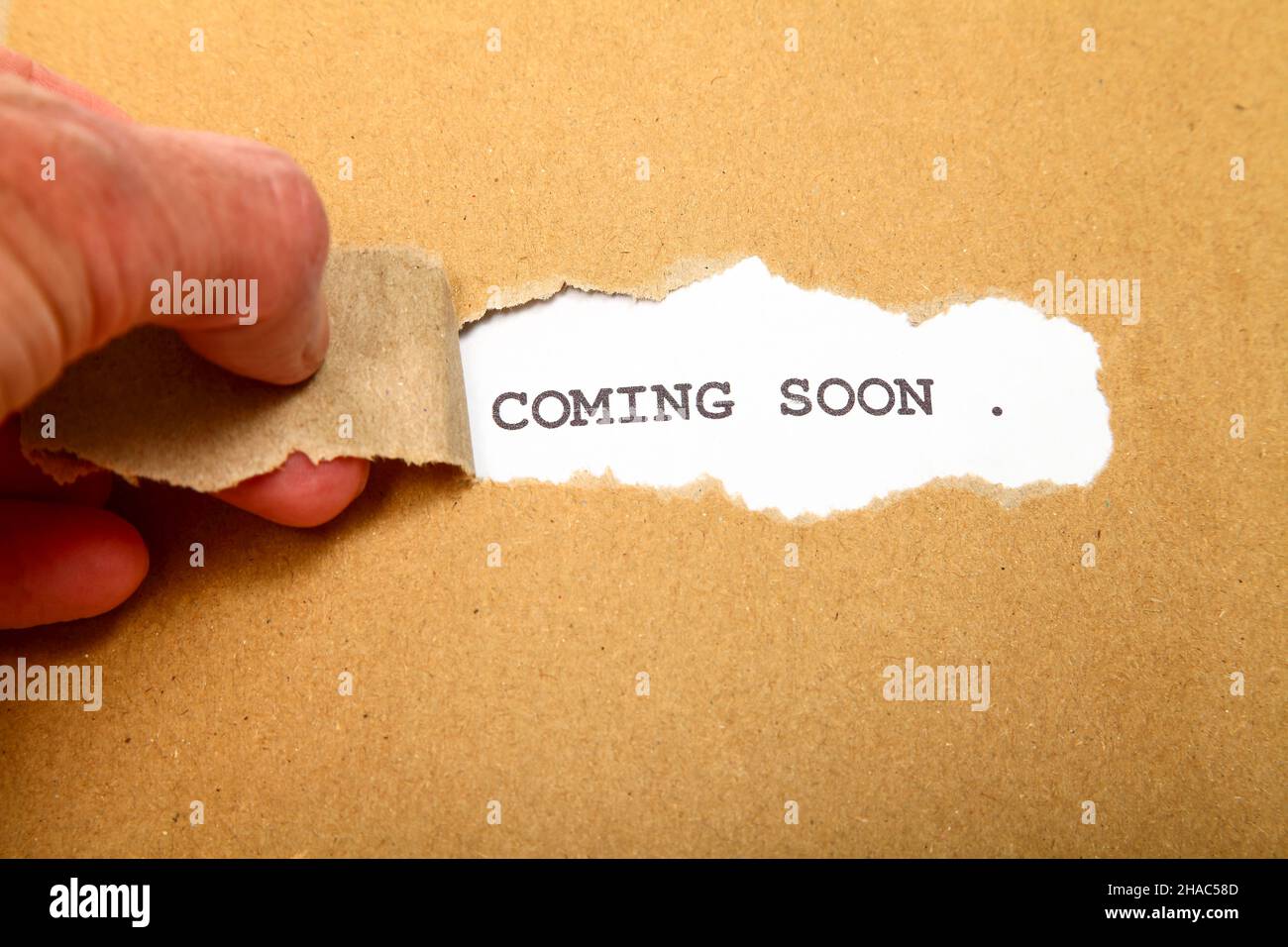 Mans Hand Pulling Back Ripped Brown Paper To Reveal The Words Coming Soon Stock Photo Alamy mans-hand-pulling-back-ripped-brown-paper-to-reveal-the-words-coming-soon-stock-photo-alamy