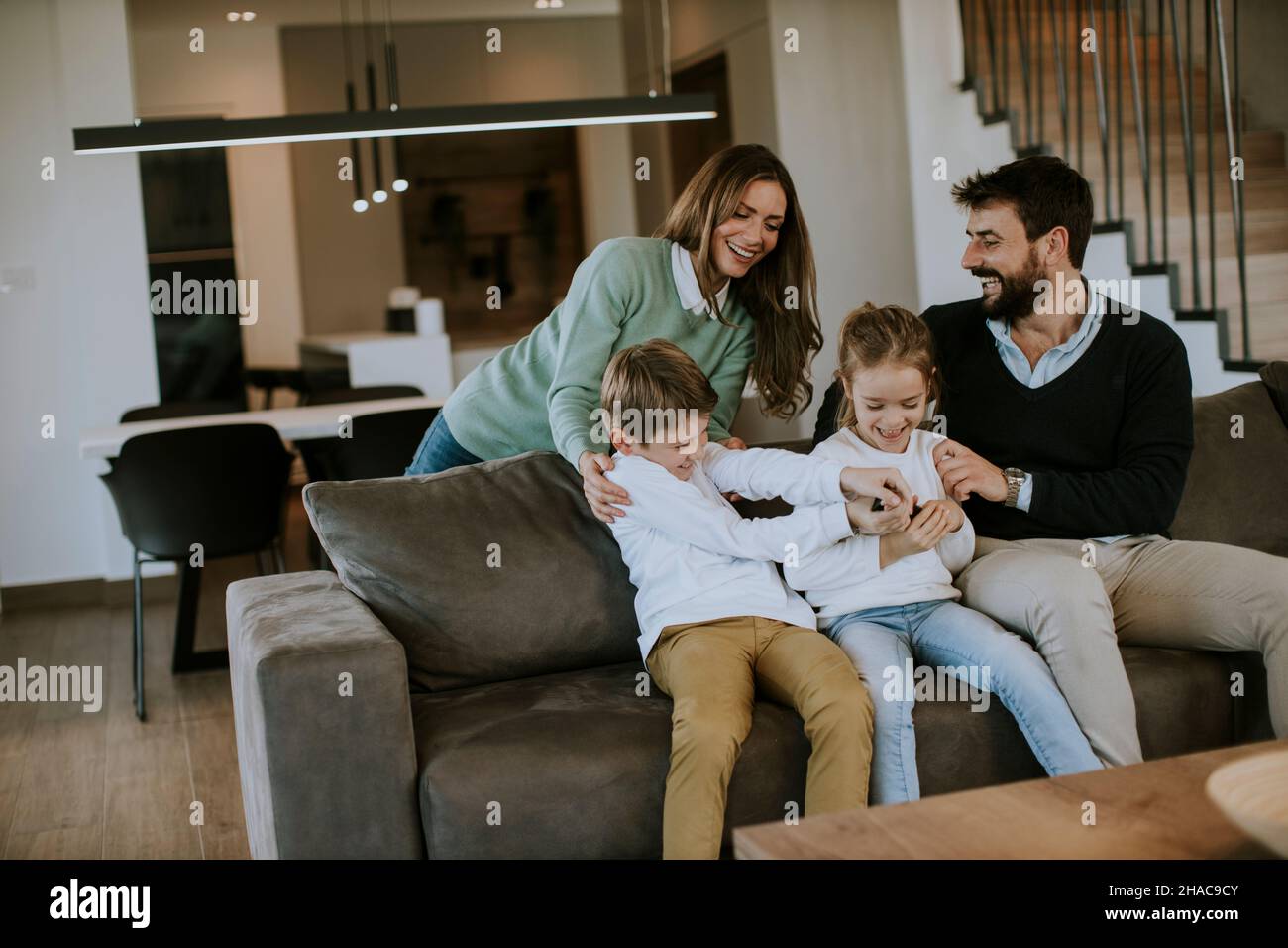Cute siblings fighting over TV remote control at home Stock Photo - Alamy
