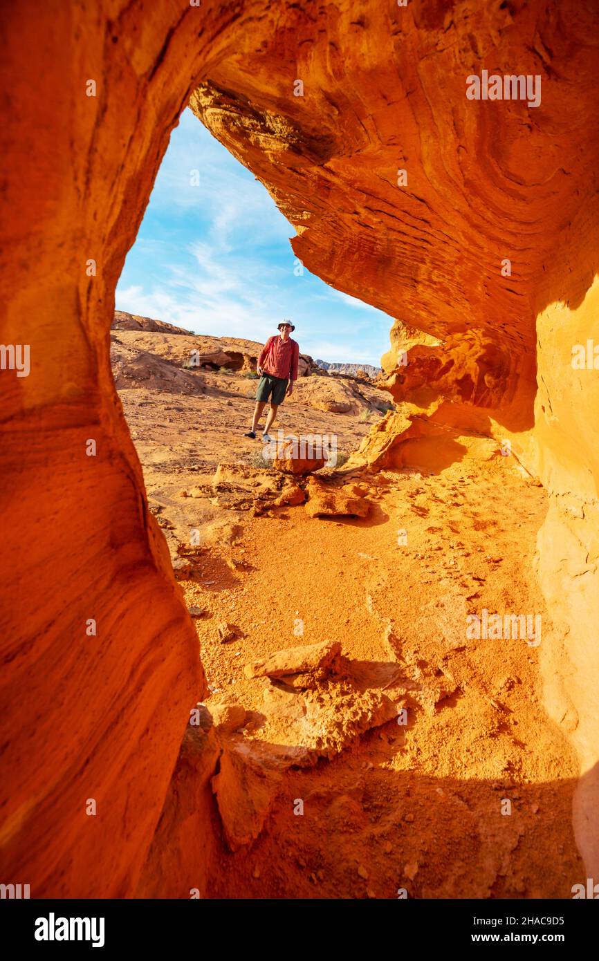 Hiker inside a stone arch in the Nevada desert near Las Vegas, Nevada ...