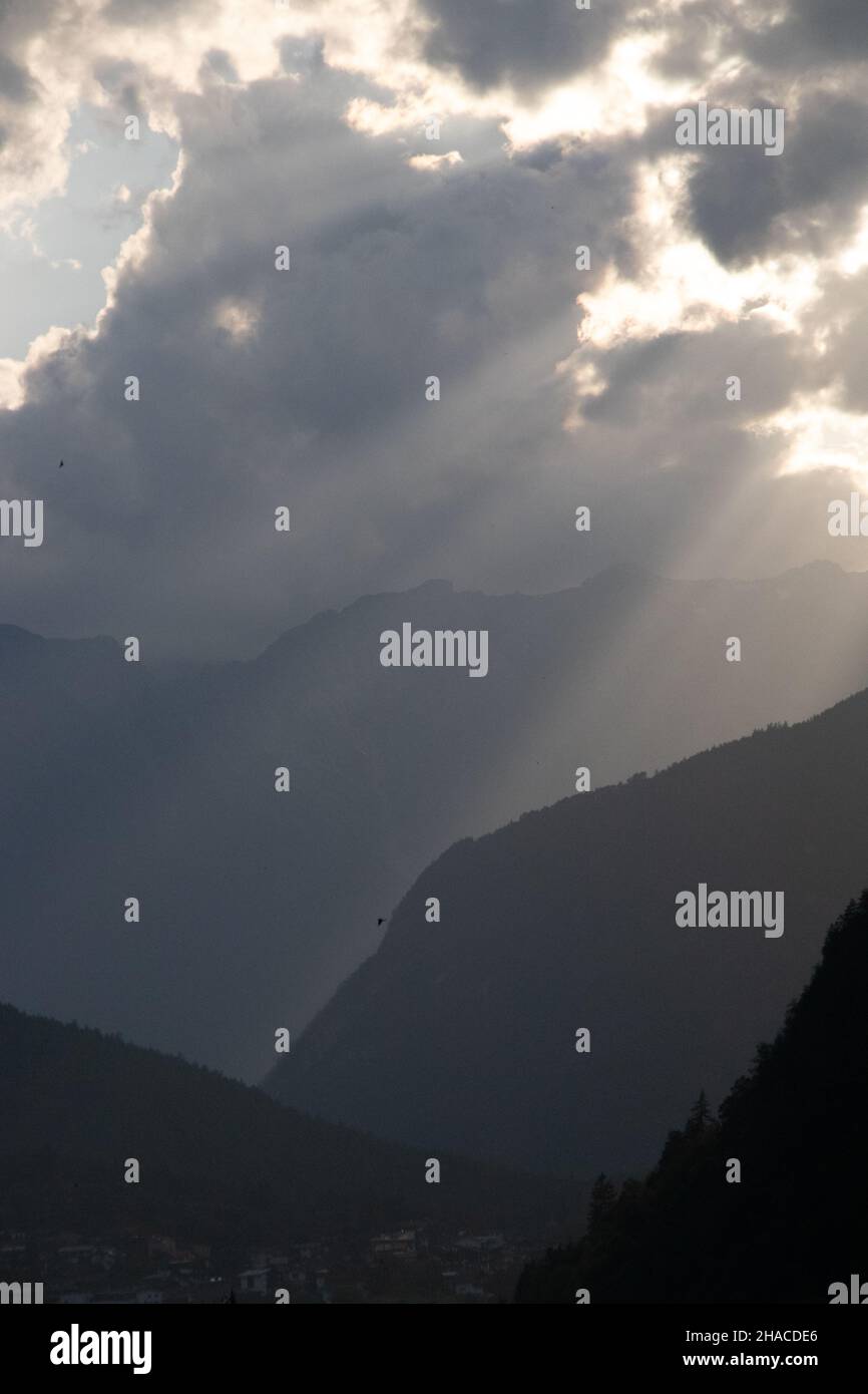 A vertical shot of a majestic view of sun rays lighting from heavy ...