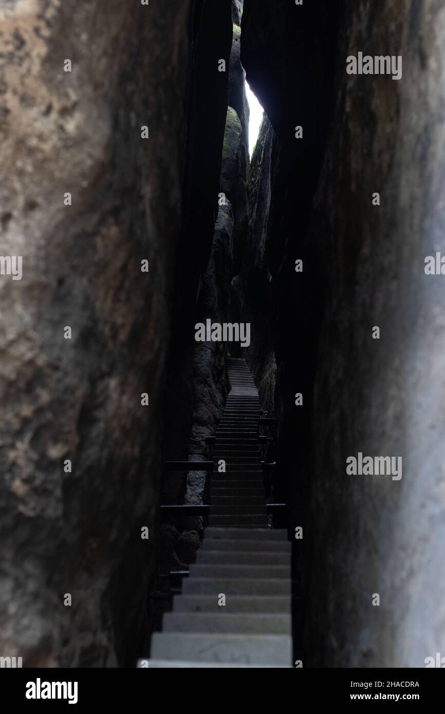 A vertical shot of narrow stairs in a cave Stock Photo - Alamy